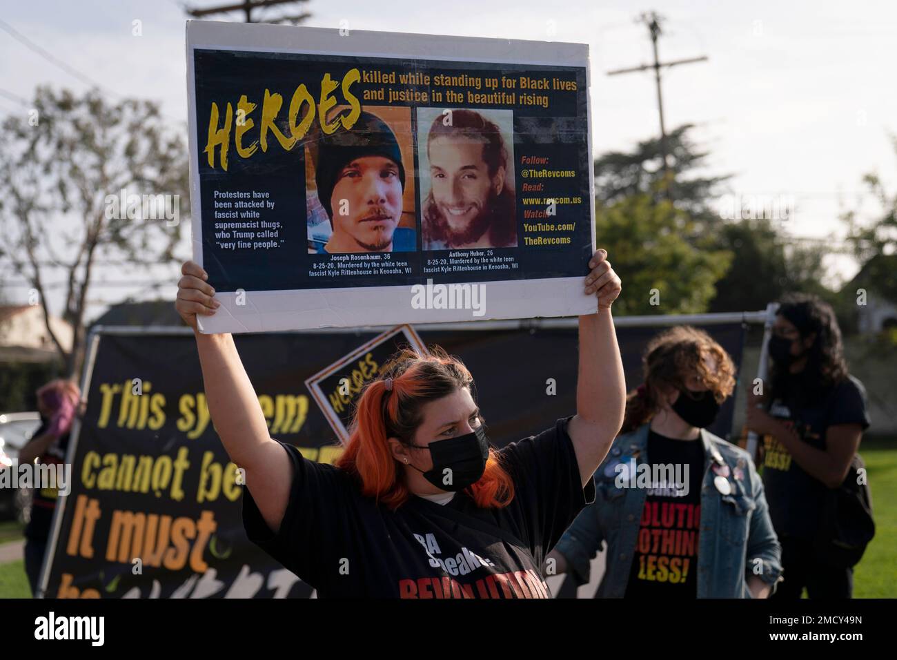 Chantelle Hershberger holds a sign showing images of Joseph Rosenbaum ...