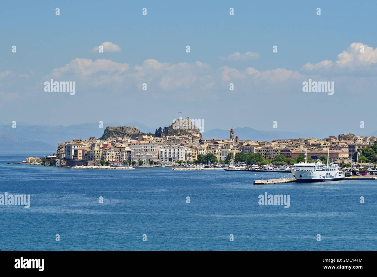 Corfu, Greece - June 2022: Waterfront of Corfu town with a ferry in the ...