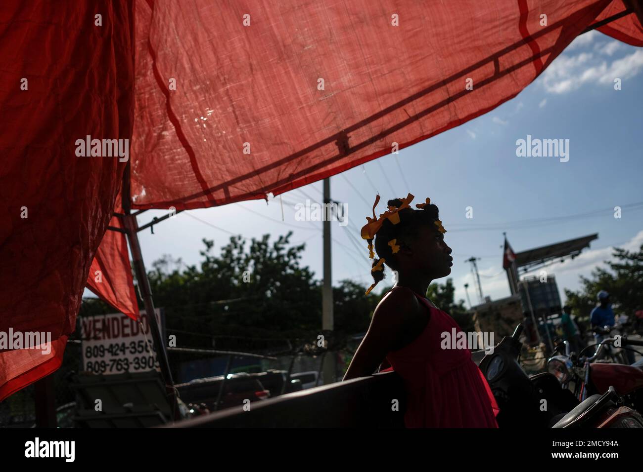 A girl stands under an awning in Dajabon border crossing, Dominican ...