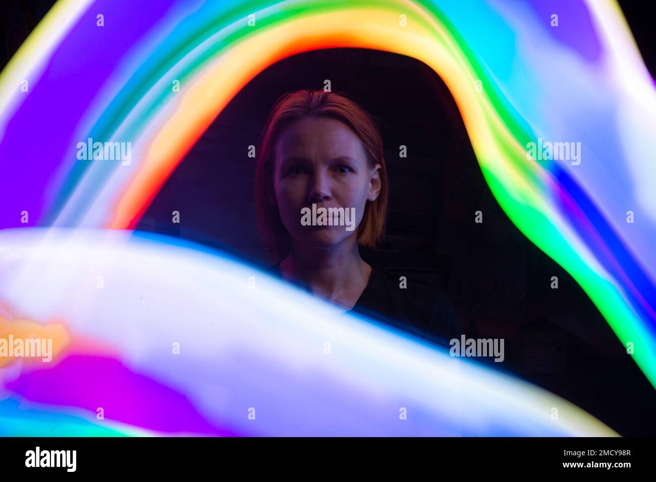 A depressed woman surrounded by colored waves Stock Photo - Alamy