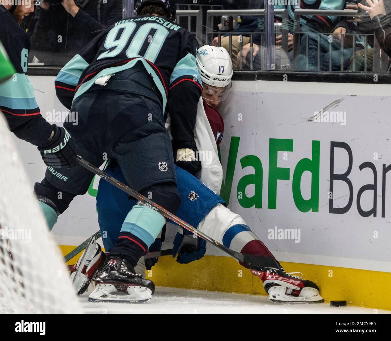 Colorado Avalanche center Tyson Jost, right is pinned to the boards by ...