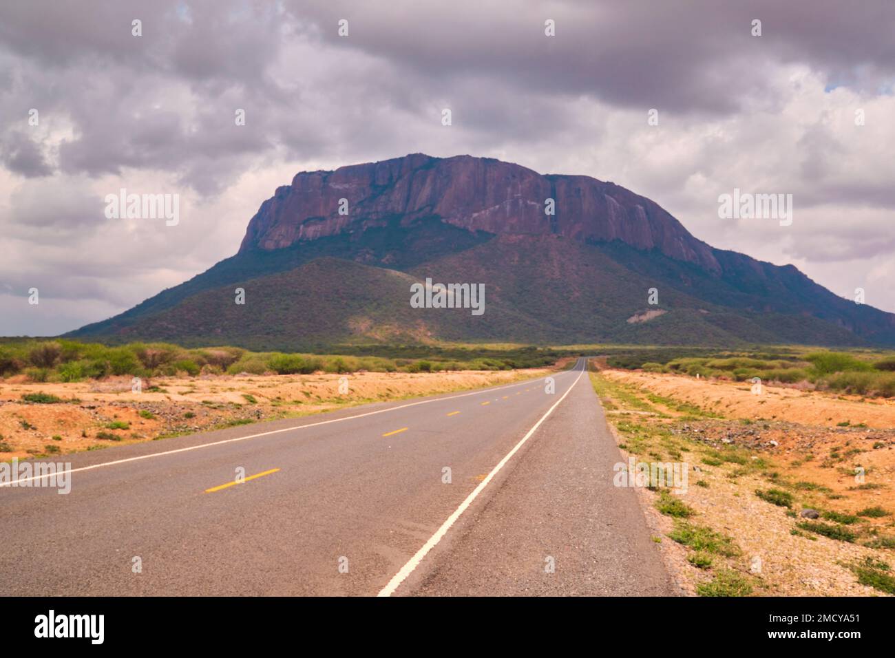 An empty highway against the background of Mount Ololokwe in Marsabit ...