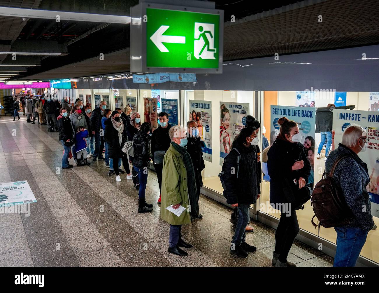 FILE - People queue in front of a small vaccination center of the local ...