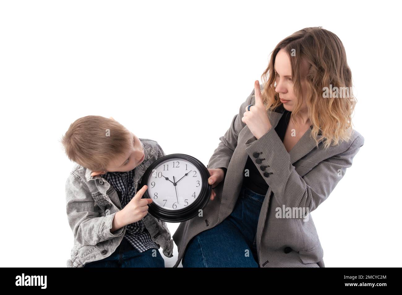 Schoolboy mom and son are studying the clock. Isolated over white ...