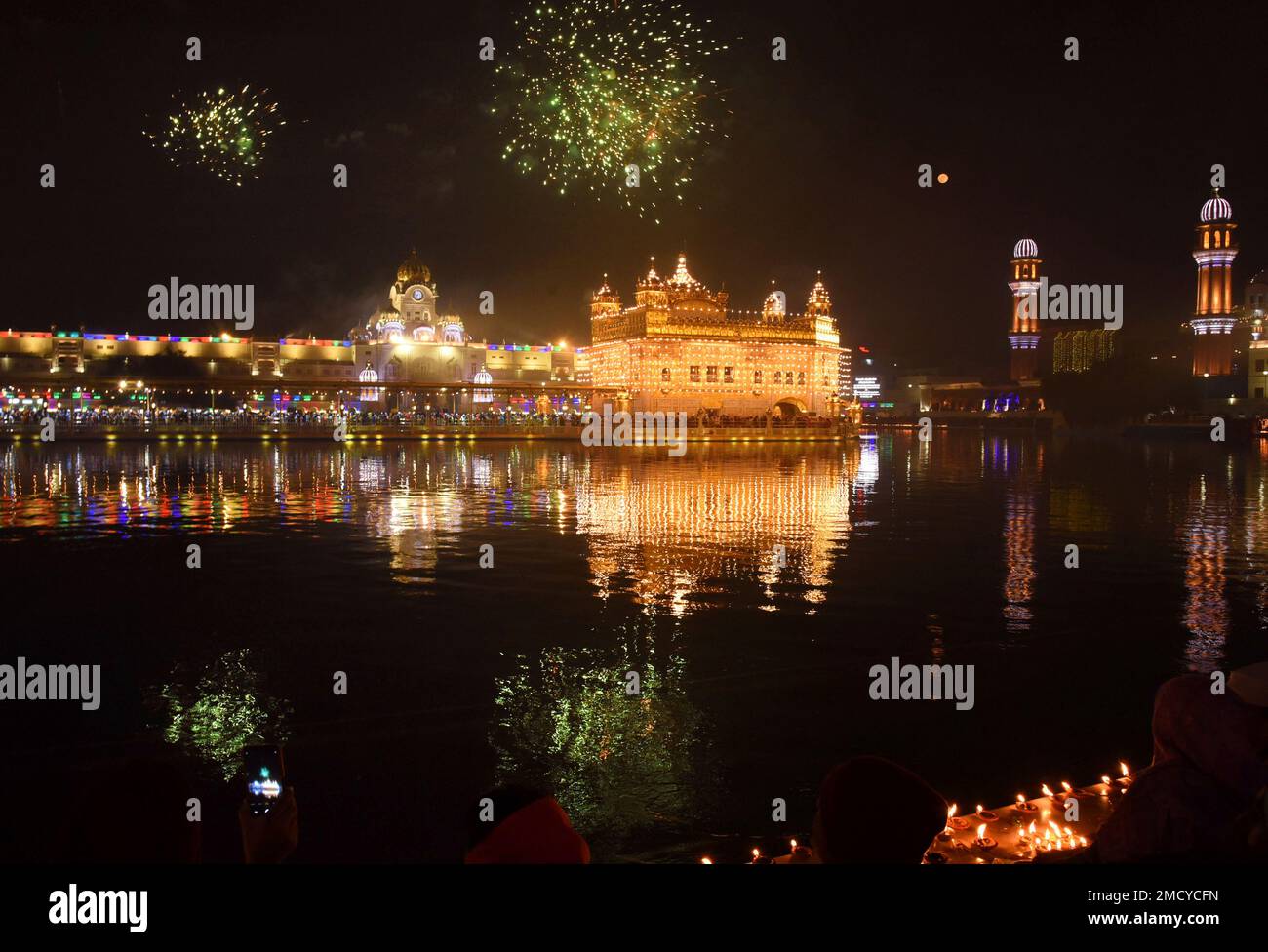 A show of fireworks over the illuminated Golden Temple is seen on the ...