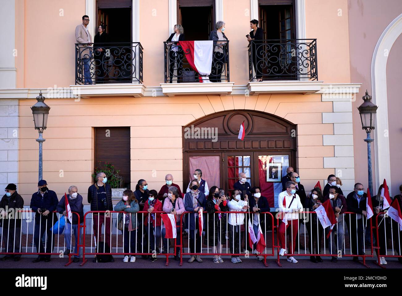 Residents wait behind security barriers outside the Monaco cathedral ...