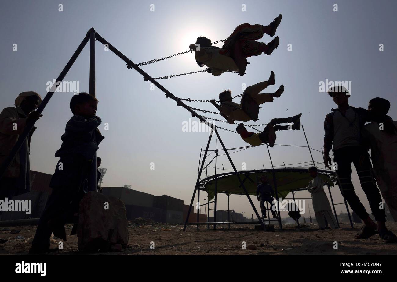 Children ride swings in a playground in Karachi, Pakistan, Friday, Nov ...