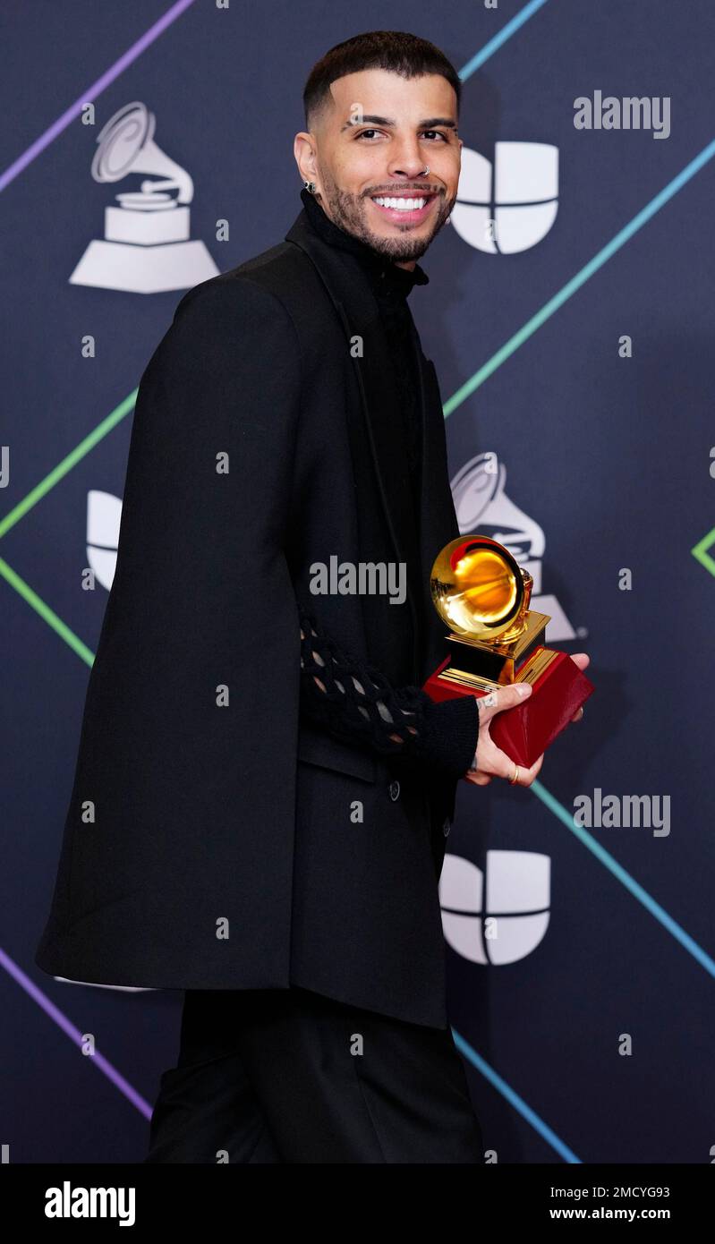 Rauw Alejandro poses in the press room with the award for best urban ...