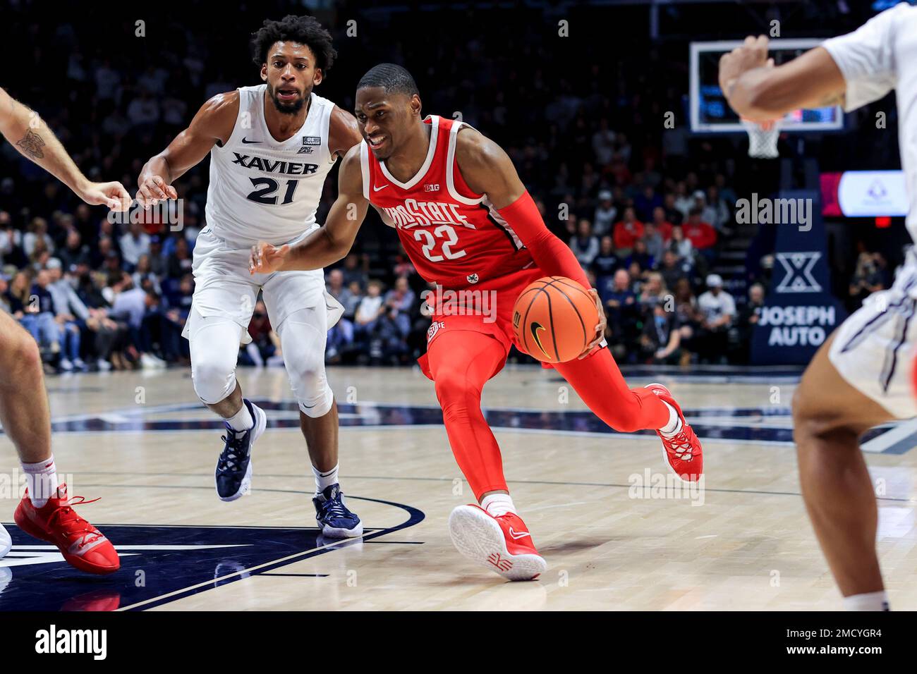 Xavier's Jerome Hunter (21) defends as Ohio State's Malachi Branham (22 ...