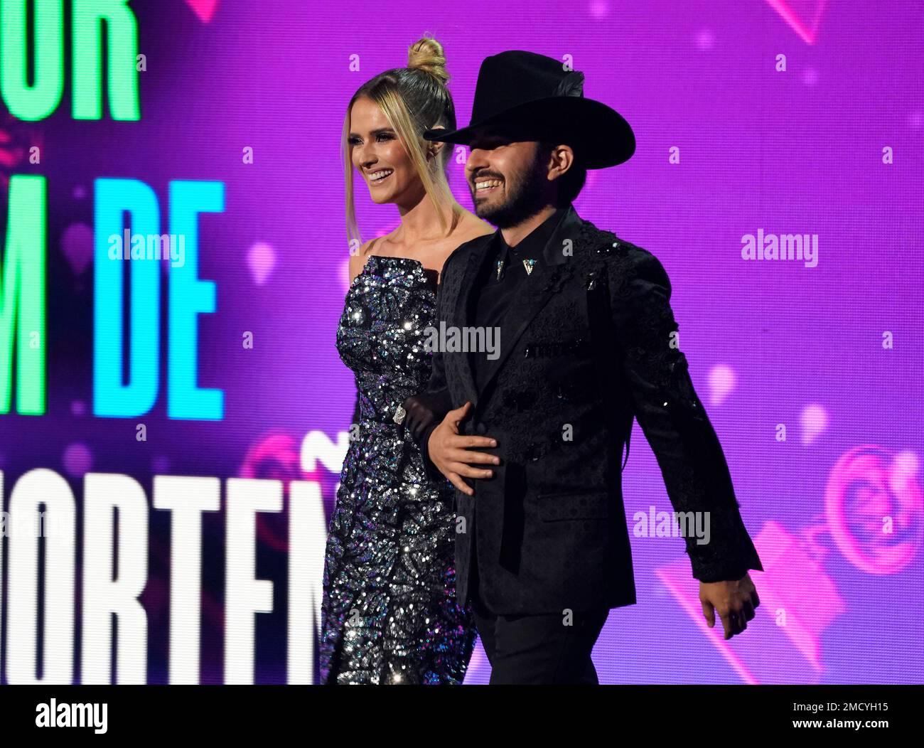 Kimberly Dos Ramos, left, and Joss Favela present the award for best ...