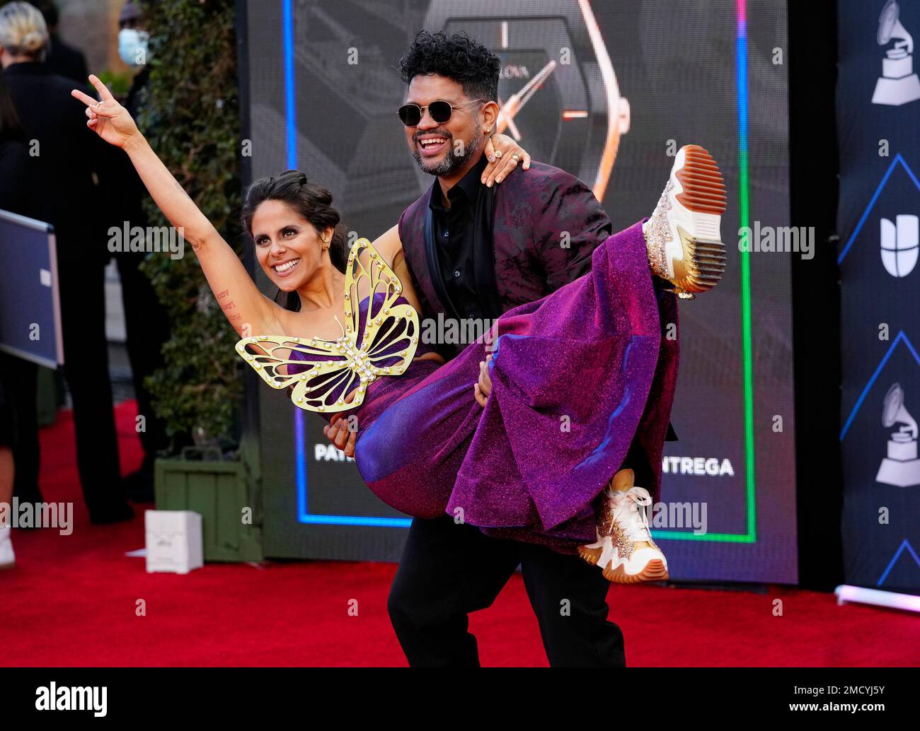 Wizzmer, right, carries AleMor as they arrive at the 22nd annual Latin ...