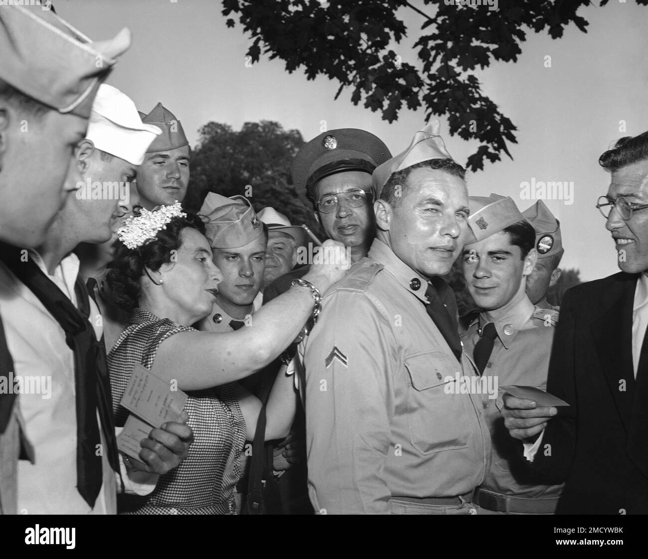Assistant Secretary of Defense Anna M. Rosenberg uses the back of a ...