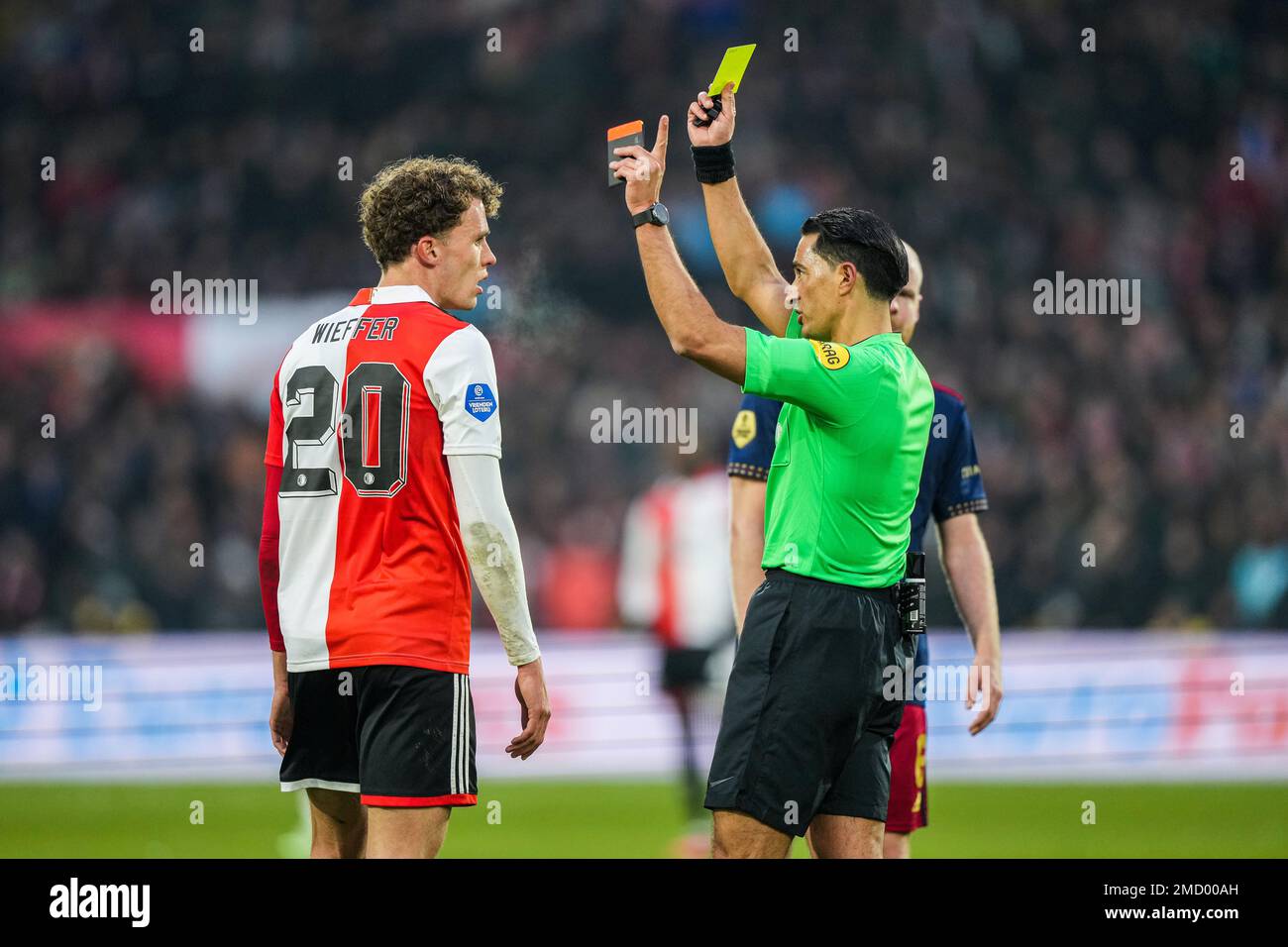 Rotterdam - Mats Wieffer of Feyenoord receives a yellow card from ...