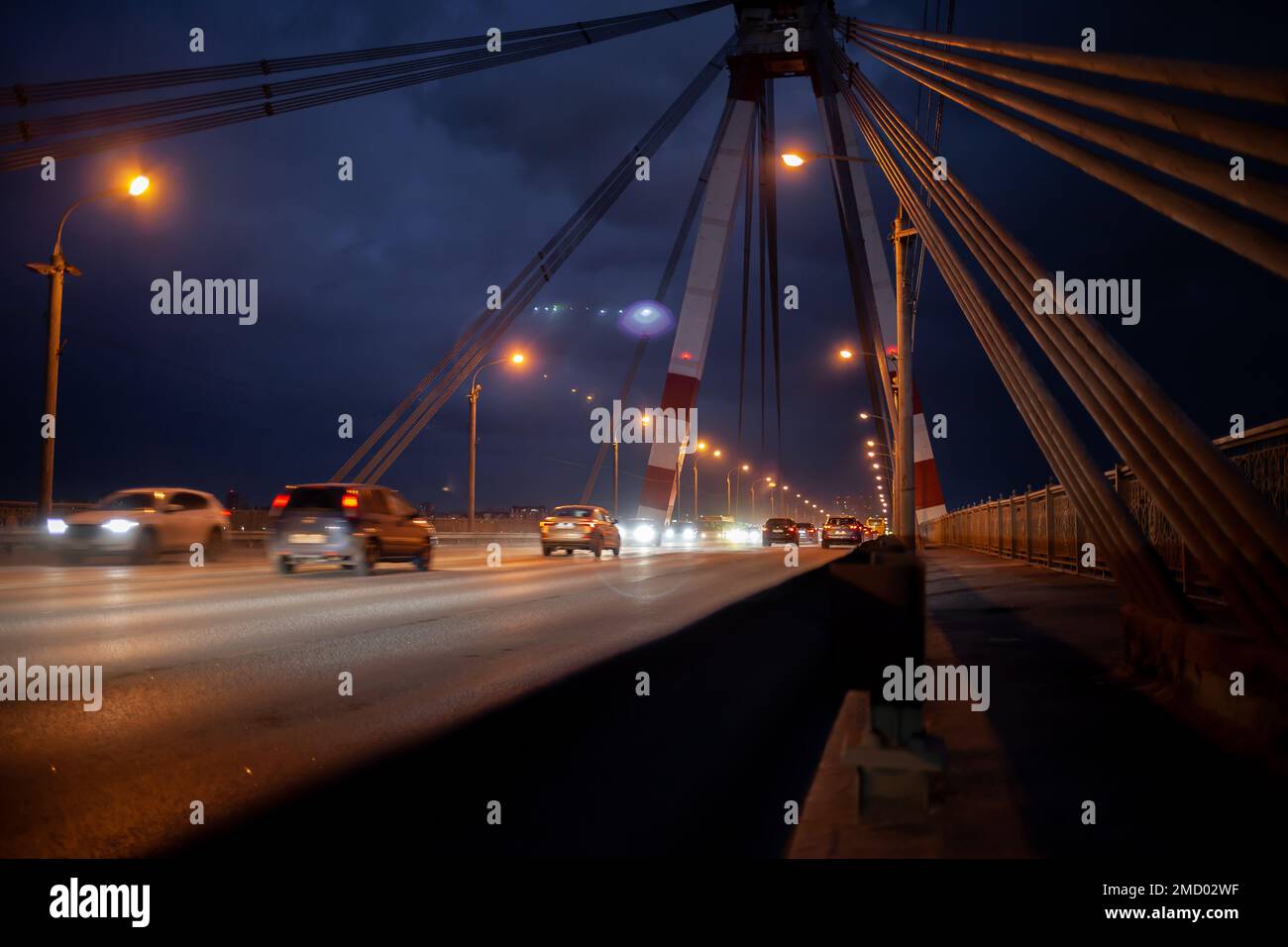 A large automobile bridge on which cars drive at night Stock Photo - Alamy