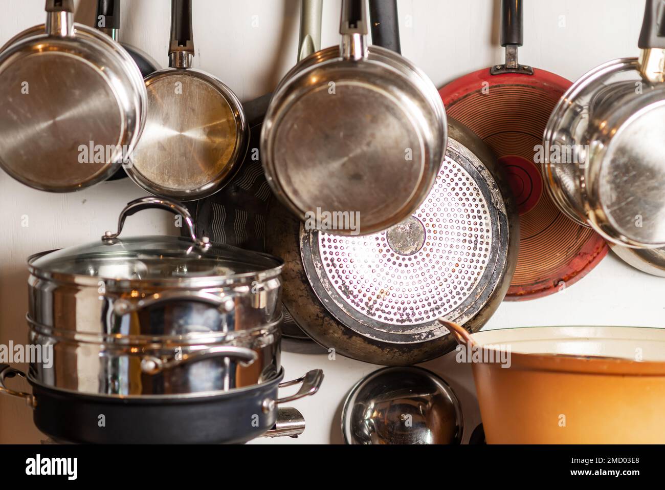 Pots and pans hang in the kitchen. Kitchen utensils, home interior ...