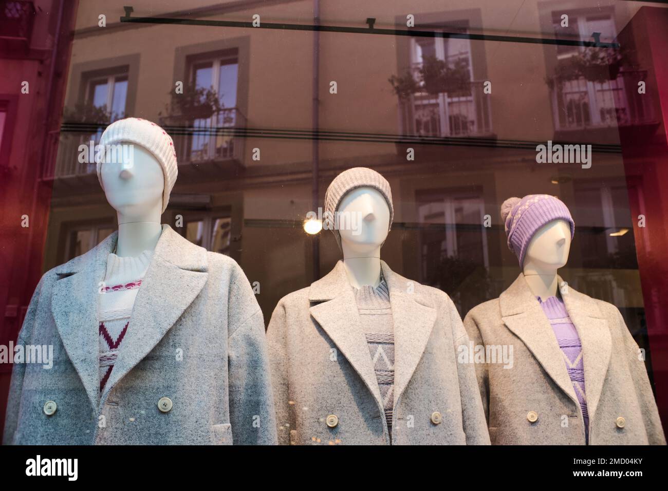 Group of three dummies in a fashion store with as background a ...