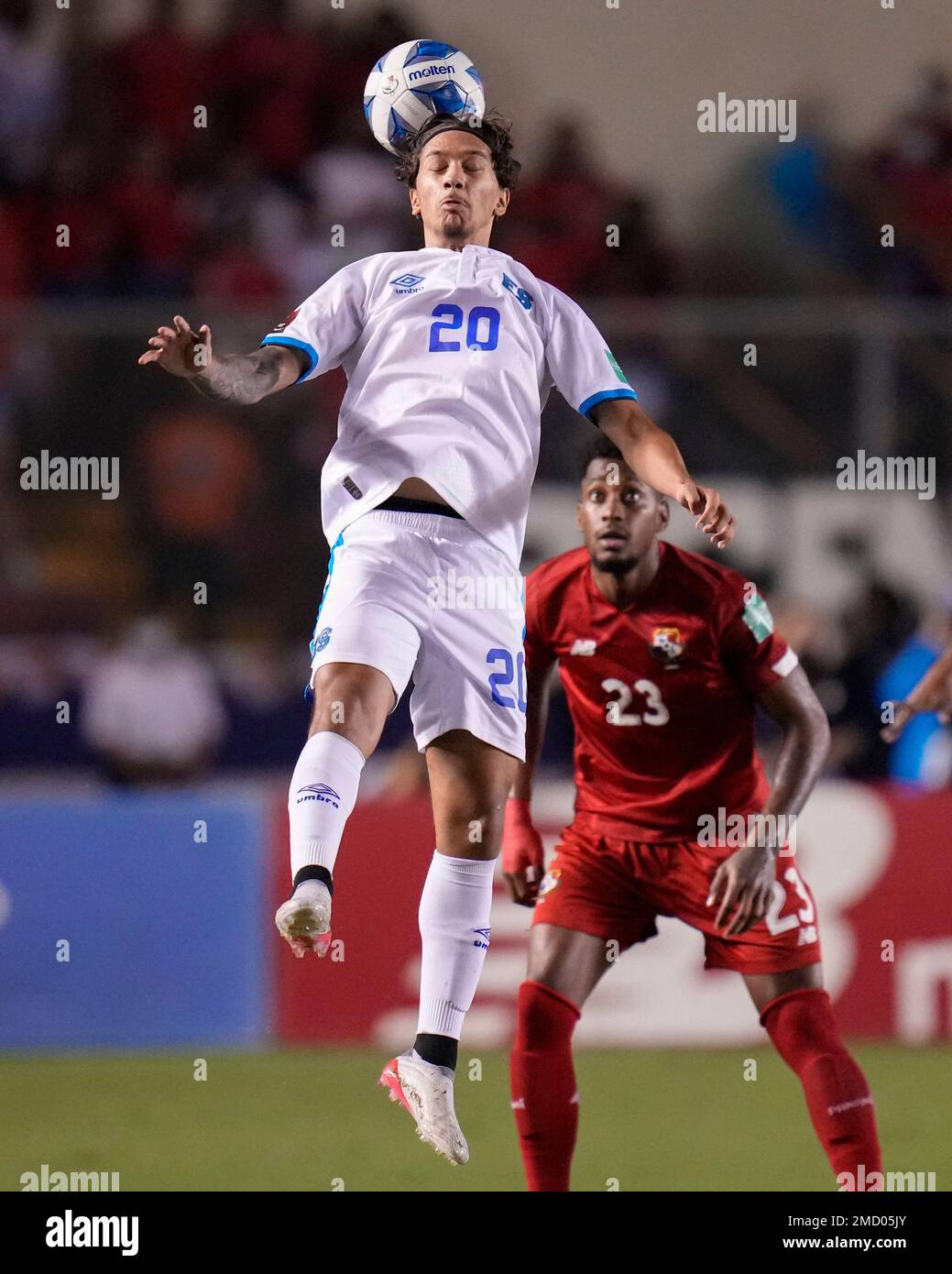 El Salvador's Enrico Duenas heads the ball as Panama's Michael Murillo looks on during a ...