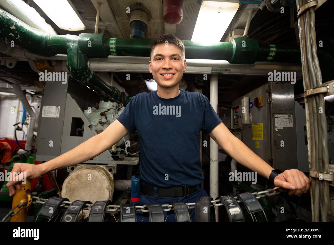 U.S. Coast Guard Fireman Matteo Tanaka poses for an environmental ...