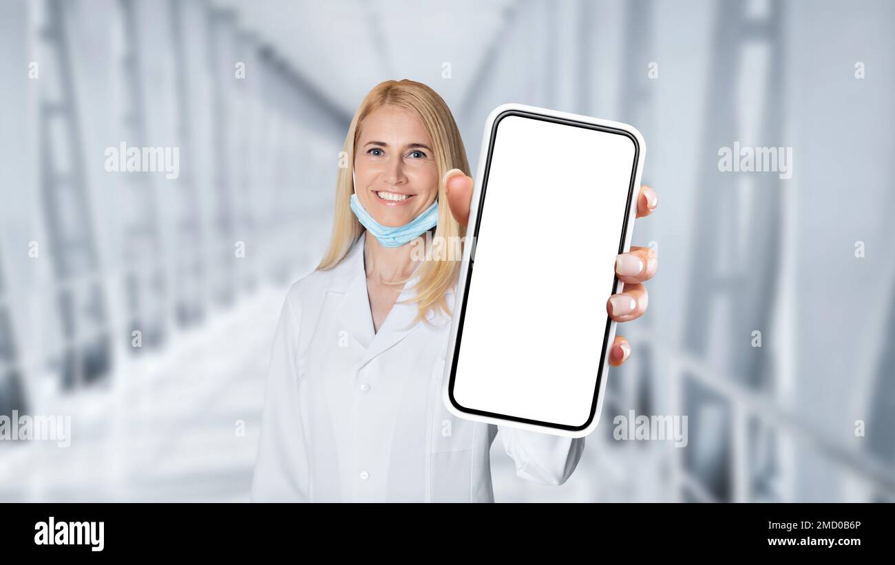 Medical Ad. Middle Aged Doctor Woman In Uniform Showing Blank ...