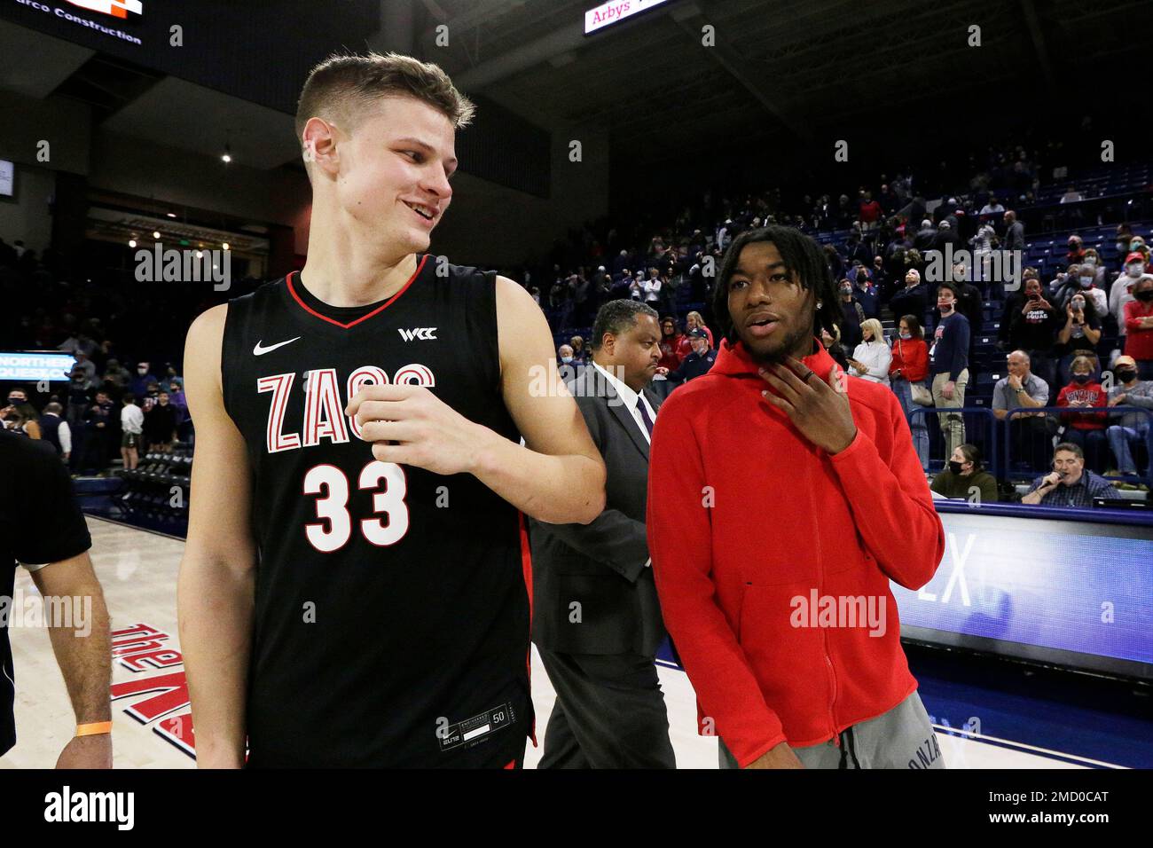 Gonzaga forward Ben Gregg, left, speaks with guard Dominick Harris, who ...