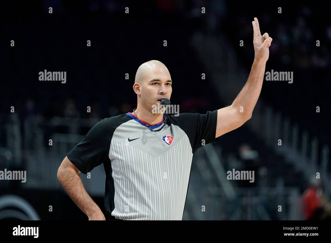 Referee Brandon Adair signals during the first half of an NBA ...