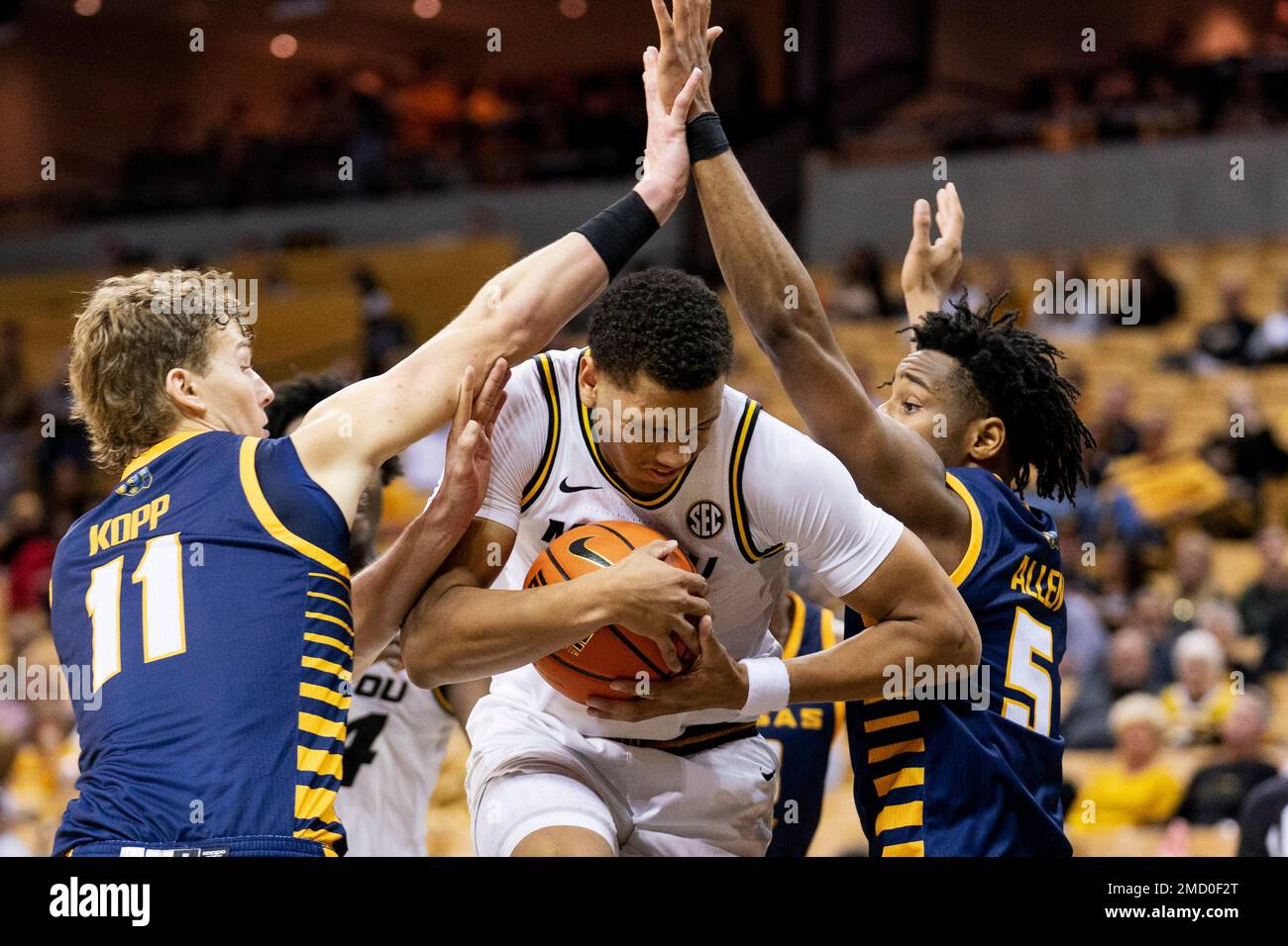 Missouri's Javon Pickett, center, fights his way between Kansas City's ...