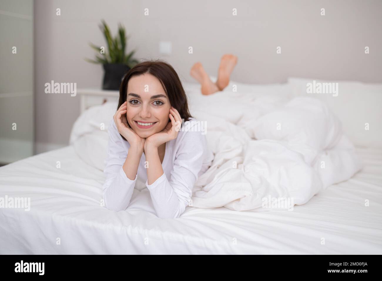 Pretty brunette woman in bed hi-res stock photography and images - Alamy