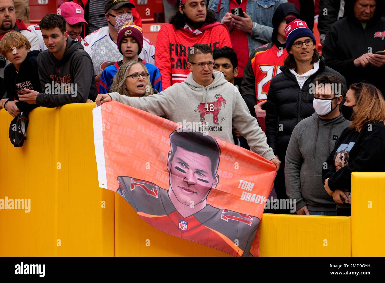 A spectator holds a banner before an NFL football game between the ...