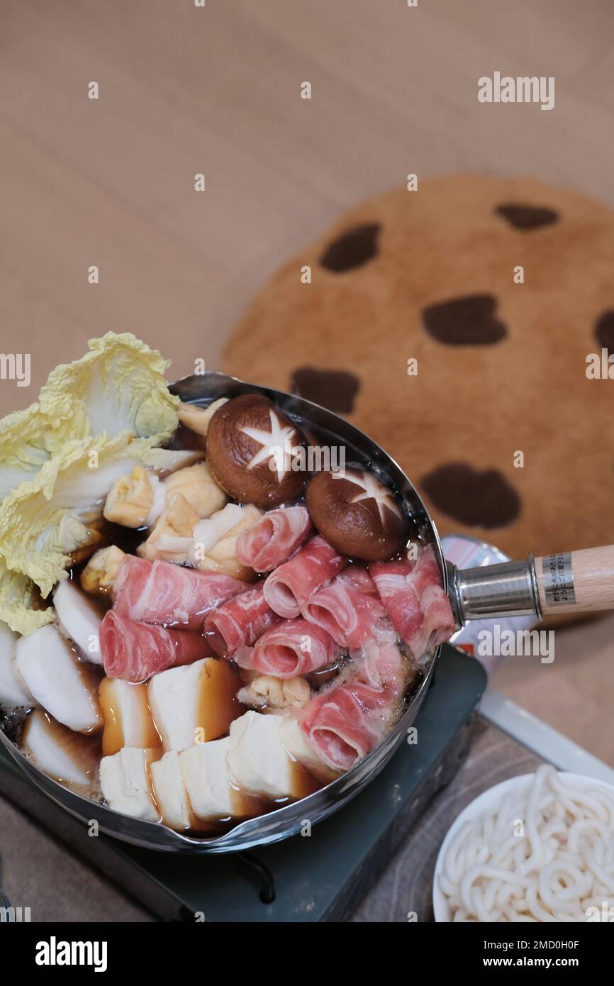 A vertical closeup of a fry pan filled with various tasty food, on a ...