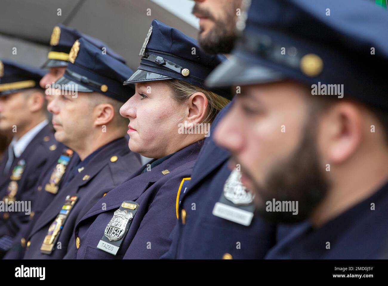 A female police officer stands with her male police department ...