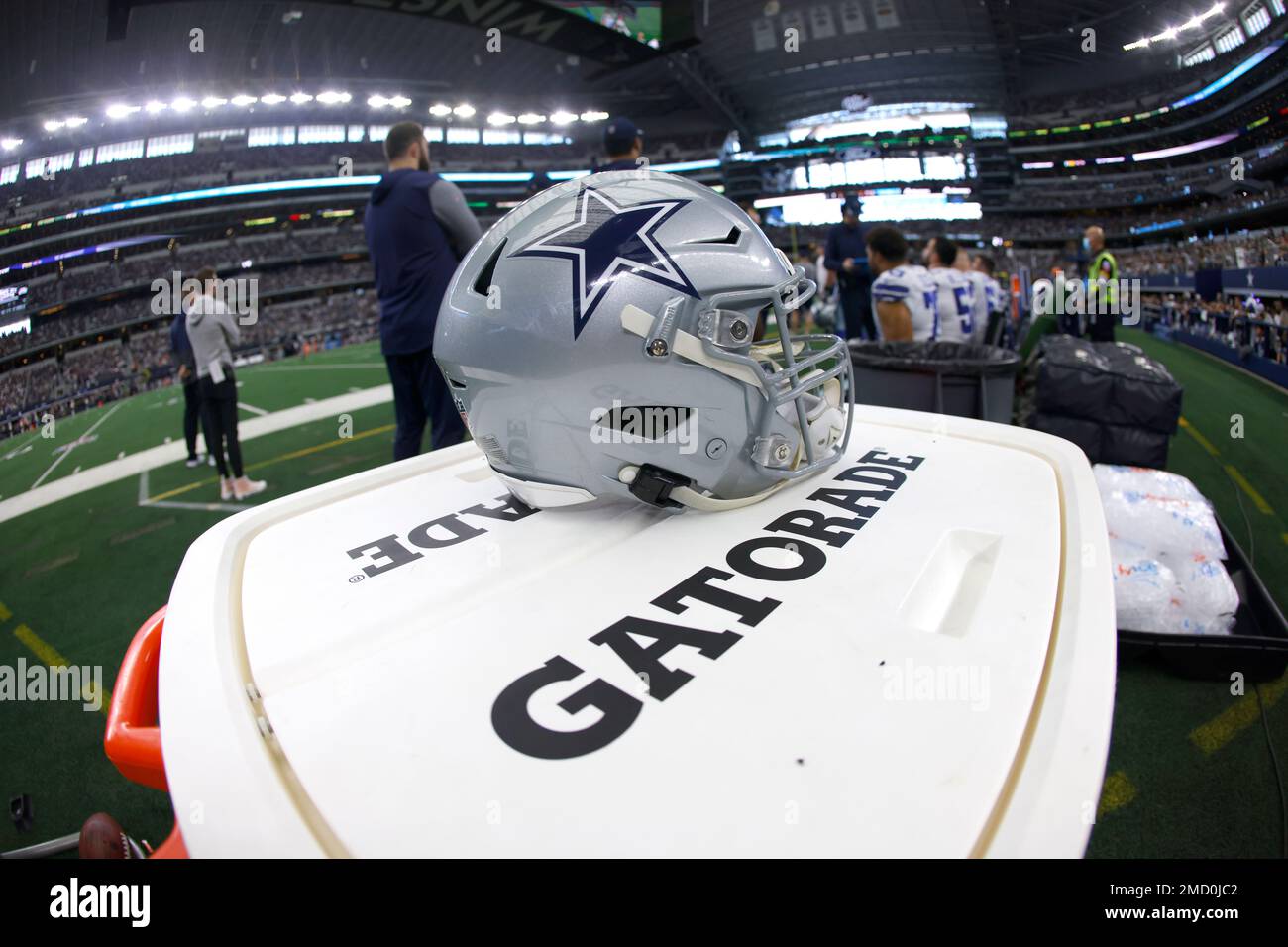 A Dallas Cowboys helmet rests on a Gatorade cooler during an NFL ...