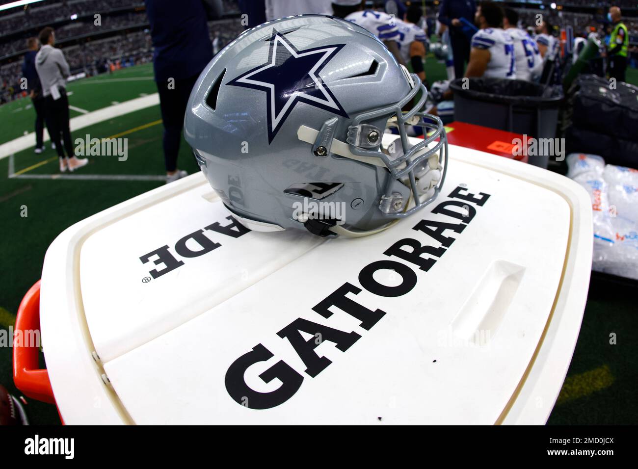 A Dallas Cowboys helmet rests on a Gatorade cooler during an NFL ...
