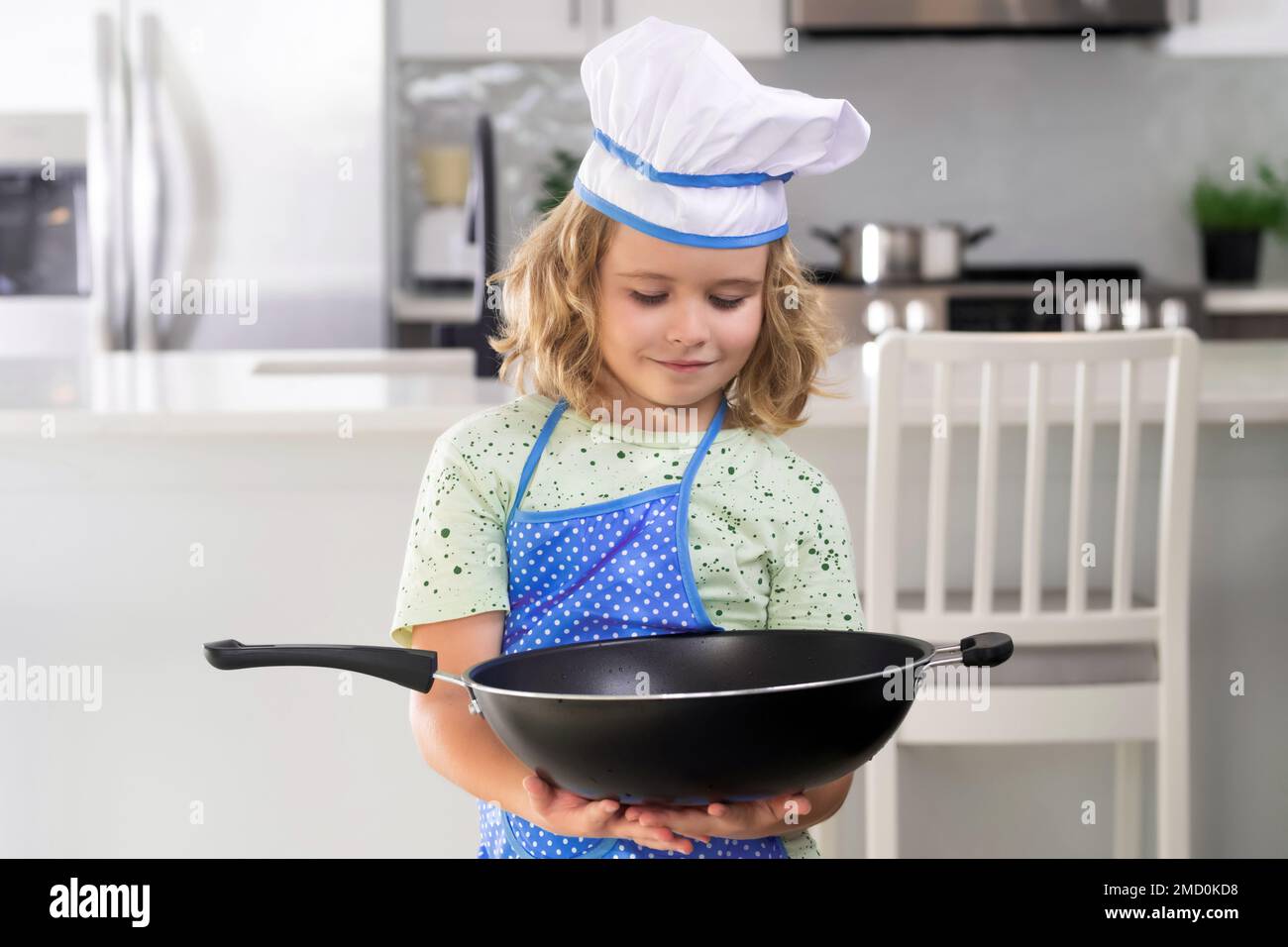 Funny kid chef cook cookery at kitchen. Chef kid boy making healthy ...