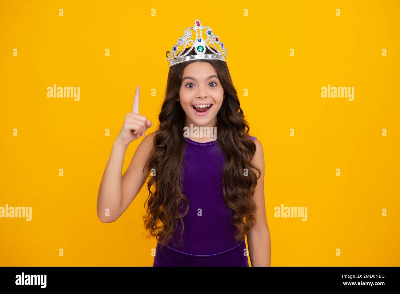 Little queen wearing golden crown. Teenage girl princess holding crown ...