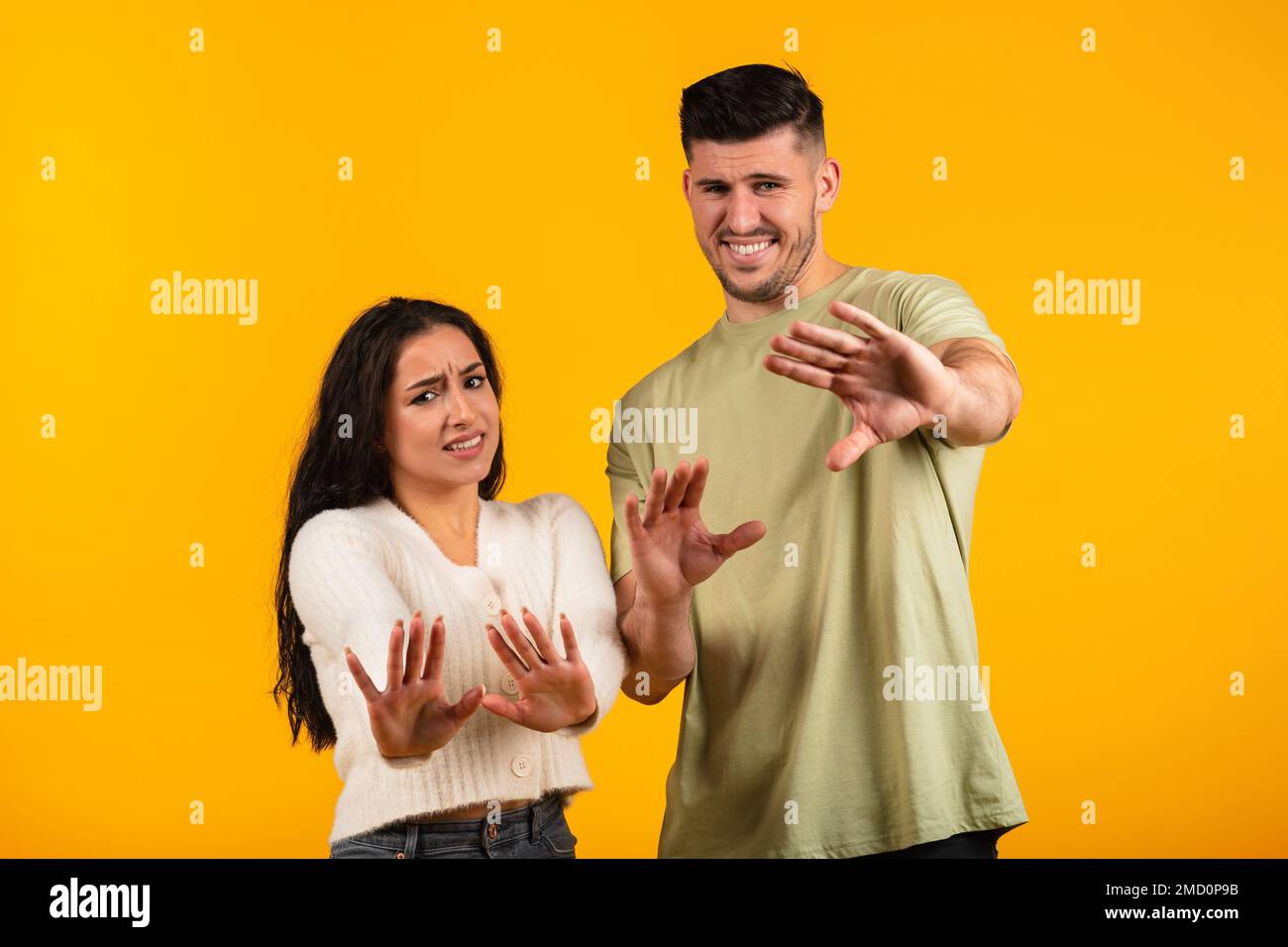 Displeased sad millennial arabic husband and wife make stop gesture ...