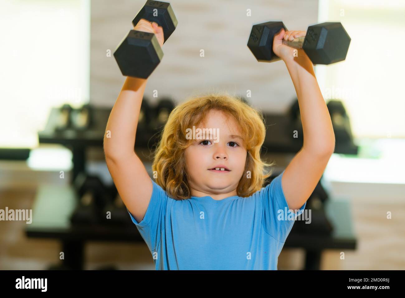 Child boy working out with dumbbells. Kids sport and active healthy ...