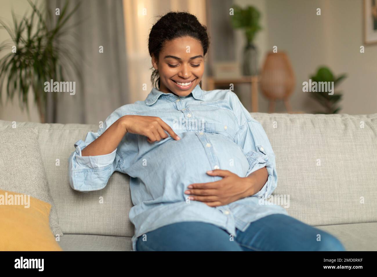 Desirable pregnancy. Happy african american pregnant lady tenderly ...