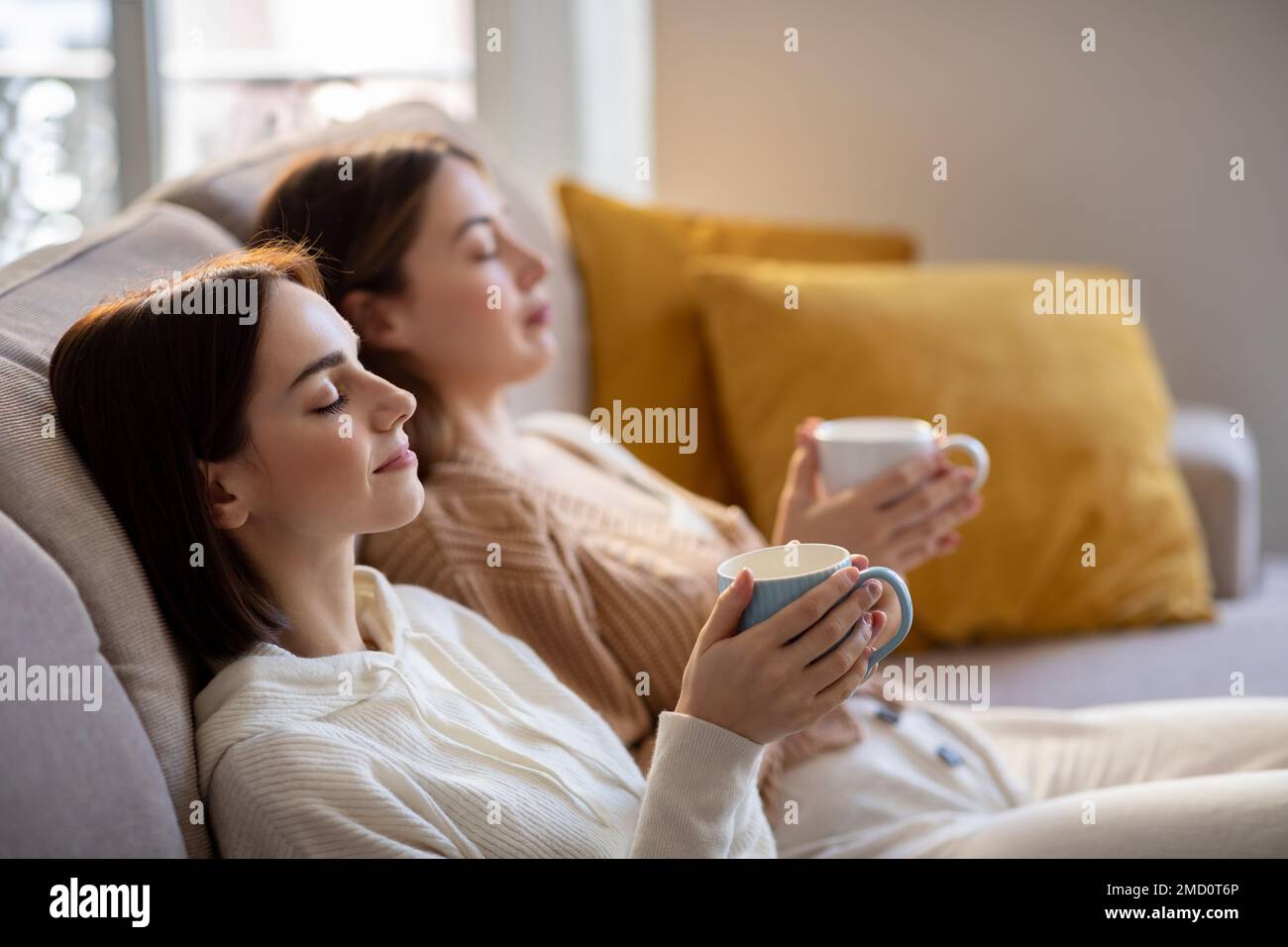 Calm european young women in casual with closed eyes relaxing, enjoy ...