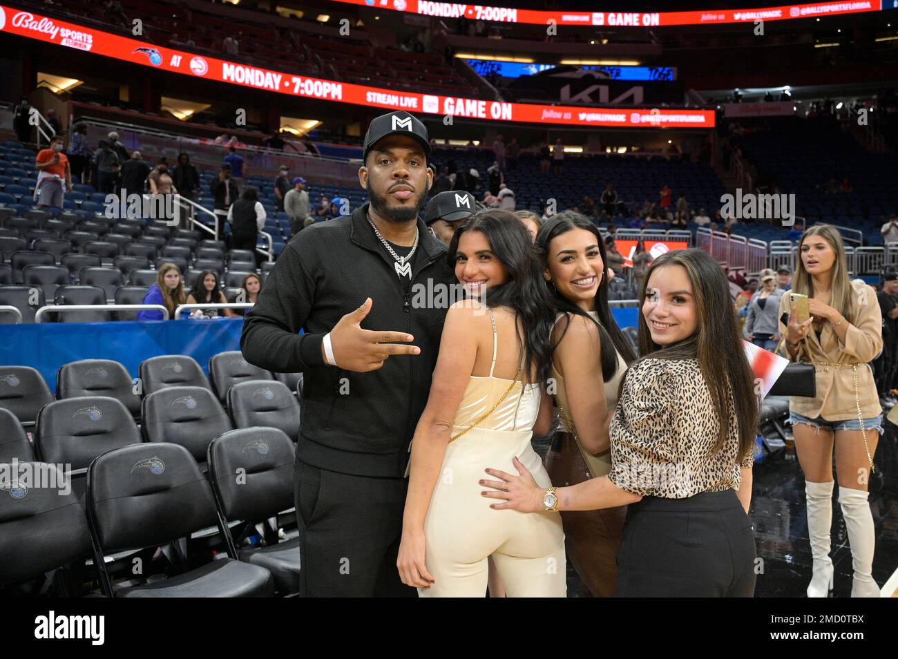 Rapper Deonte Moore, known as Moe, left, poses on the court after an ...