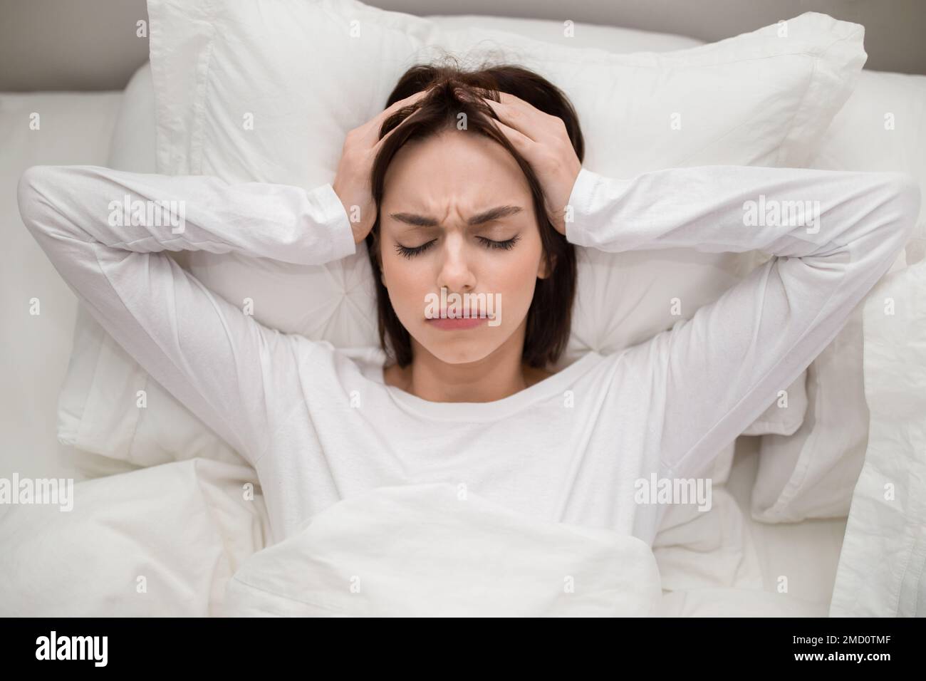 Young woman lying in bed hi-res stock photography and images - Alamy