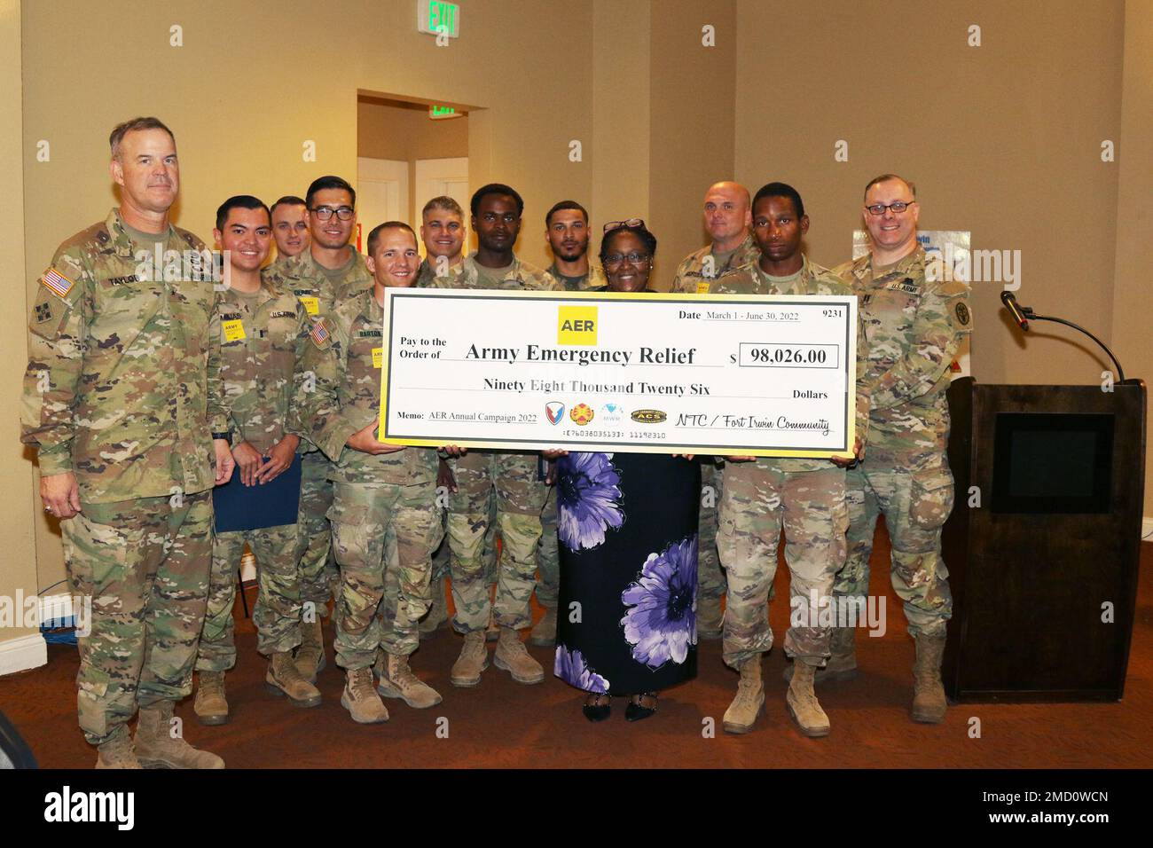 Fort Irwin Army Emergency Relief representatives pose with a check of ...
