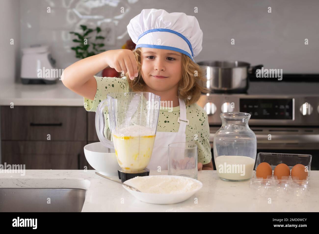 Funny kid chef cook cookery at kitchen. Chef kid boy making healthy ...