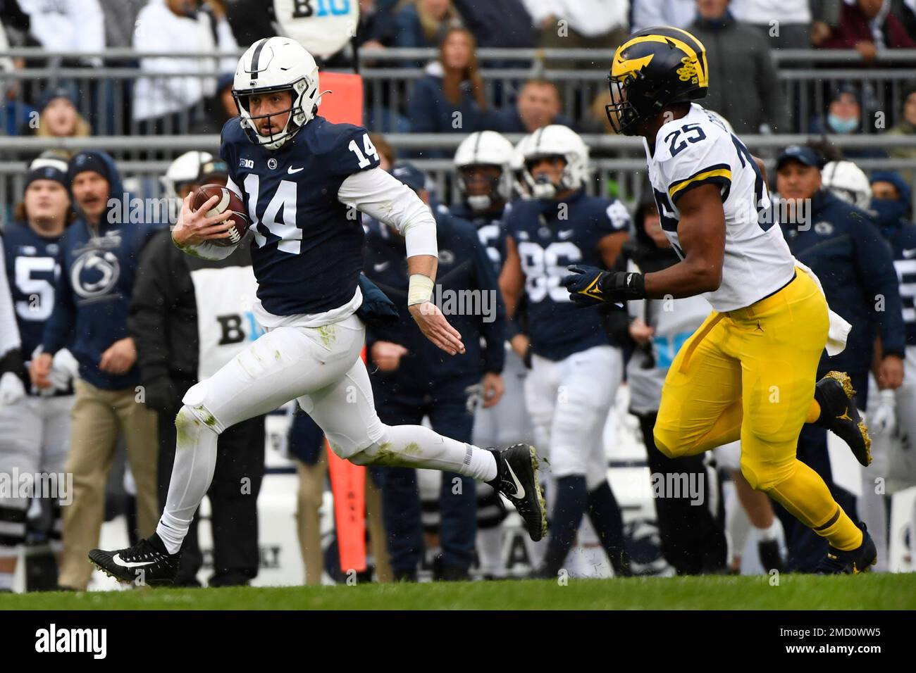Penn State quarterback Sean Clifford (14) scrambles while being chased ...