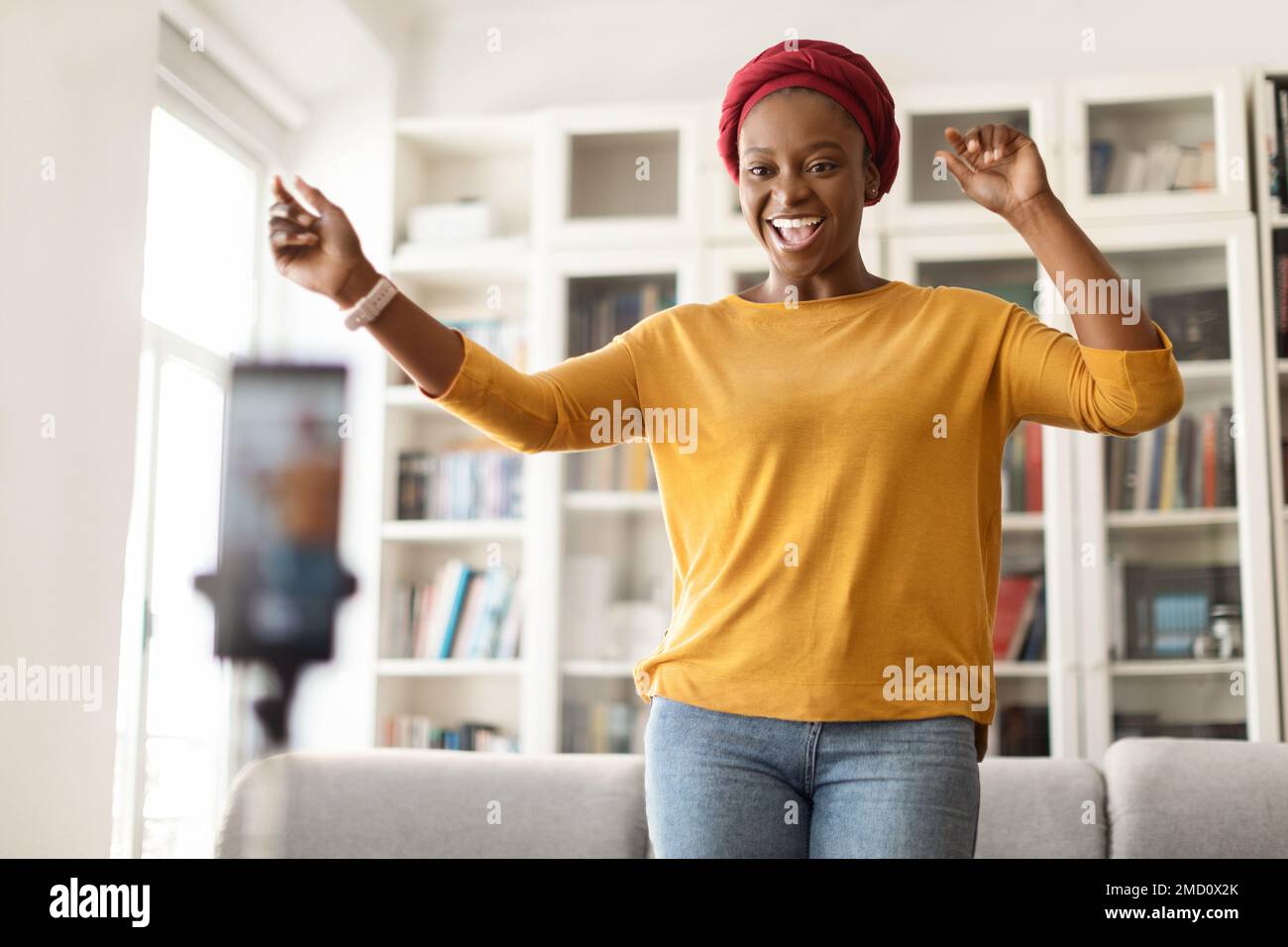 Cute african american female vlogger dancing, recording content for ...