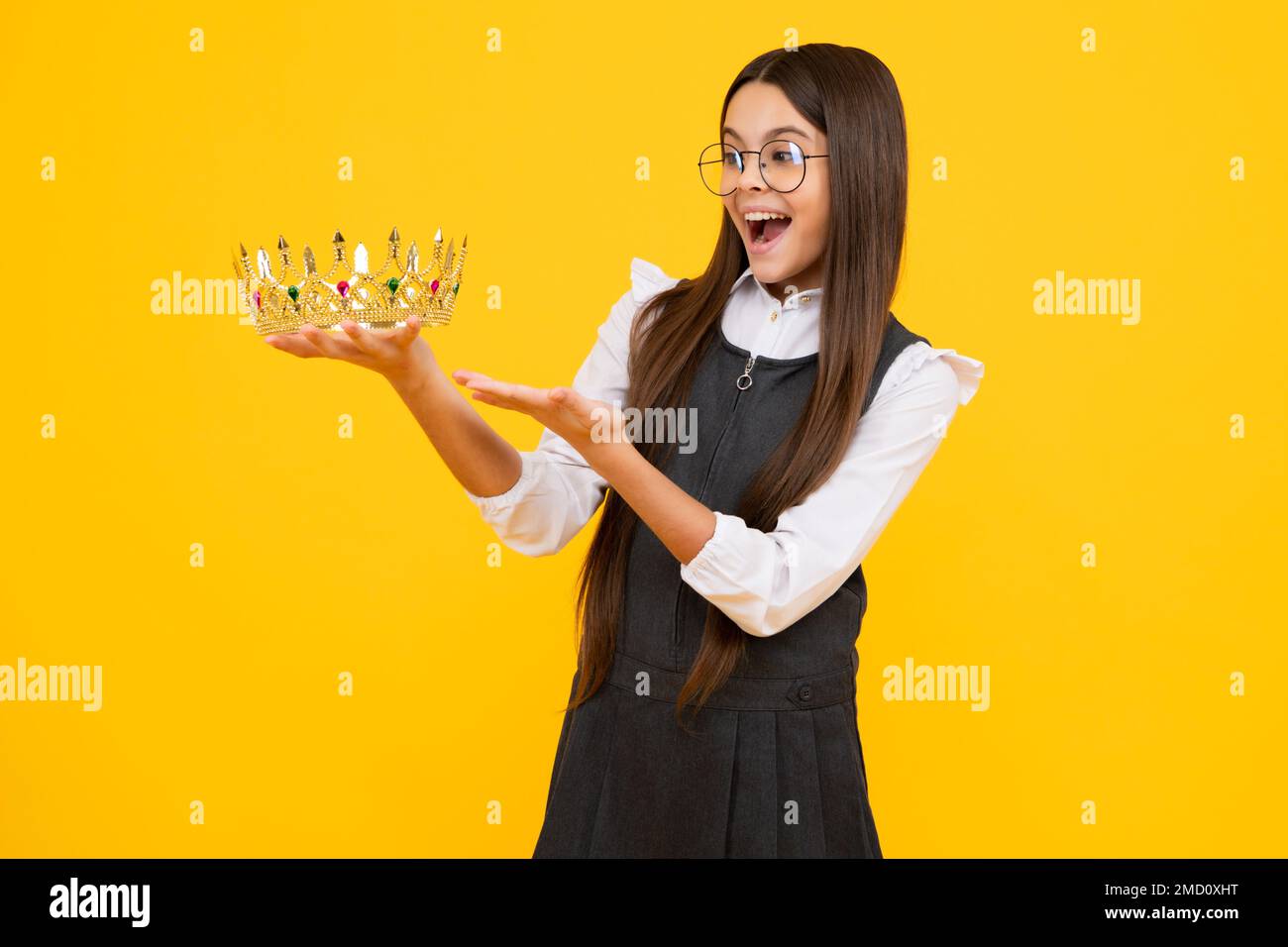 Little queen wearing golden crown. Teenage girl princess holding crown ...