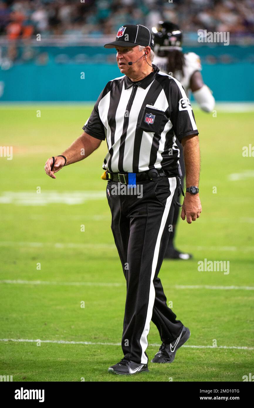 NFL line judge Mark Steinkerchner walks on the field during an NFL ...
