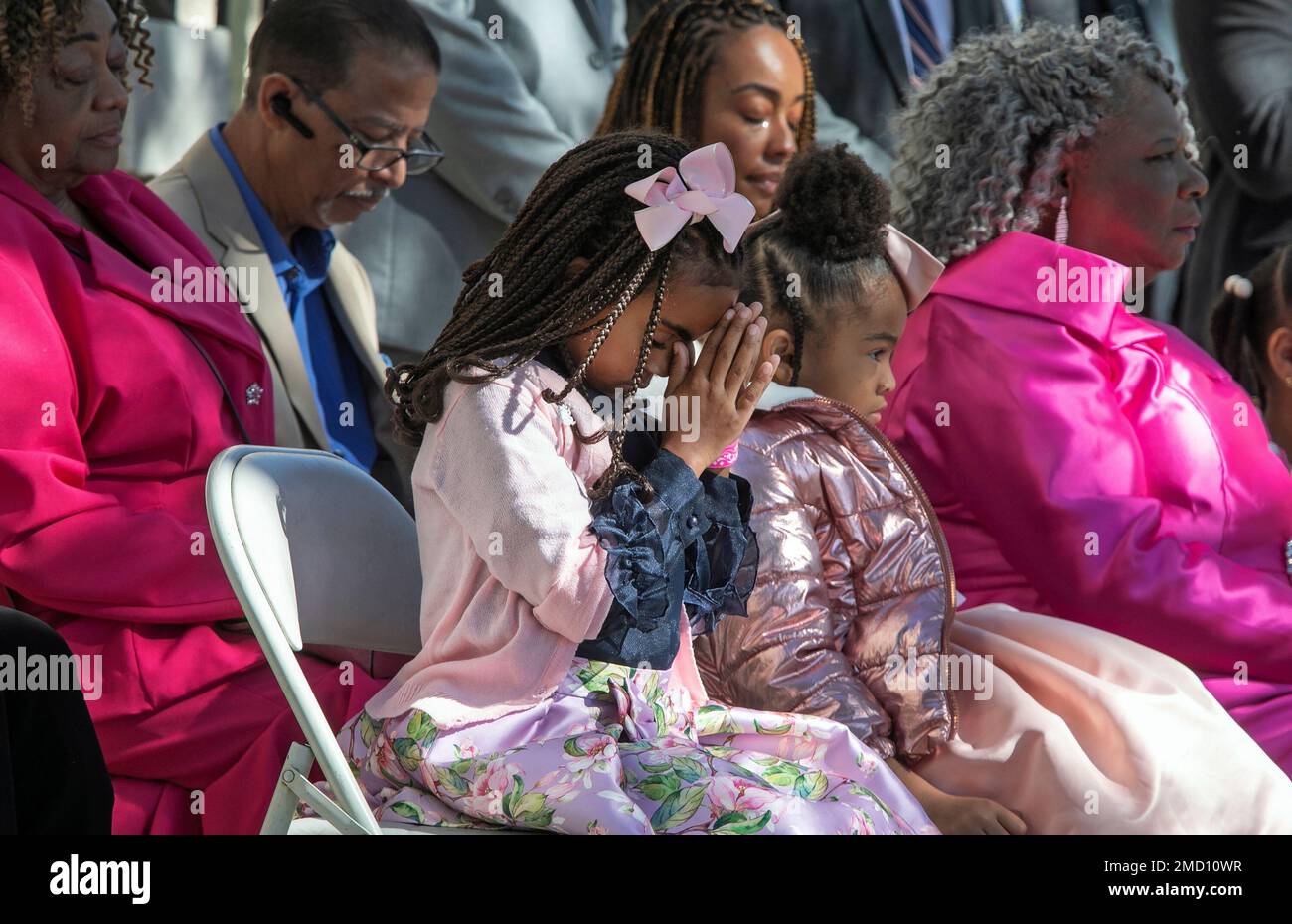 Seven-year-old Elan Jolie Hebert folds her hands in prayer during the ...