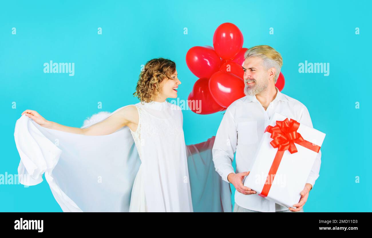 Valentines Day couple. Cupid angel with red heart balloons and present ...