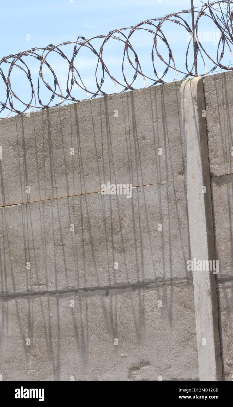 Three metre concrete walls topped by razor wire protect agricultural ...