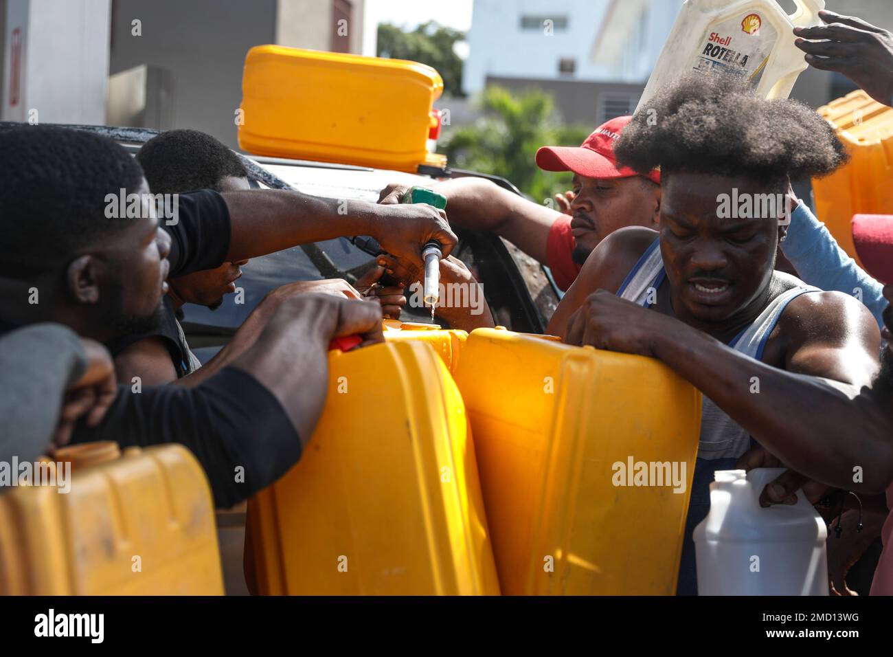 People push and shove as they try to get their gas tanks filled at a ...